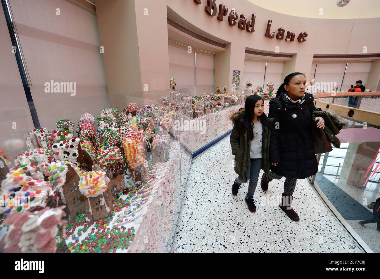 Visitors walk by gingerbread houses at the annual Gingerbread Lane ...