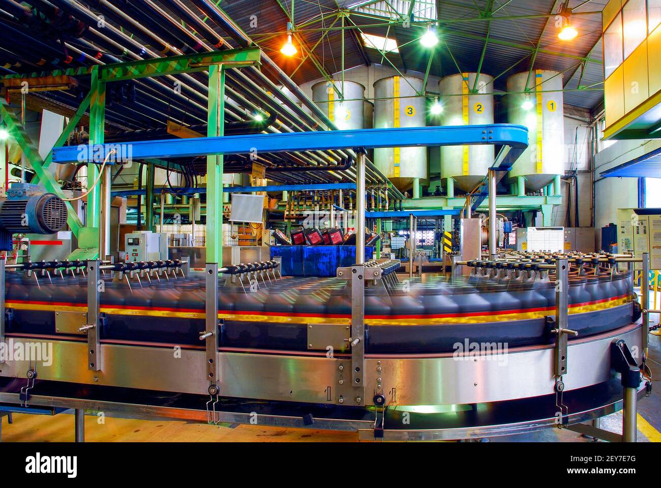 Oil is dispensed into quart bottles at a lubricant manufacturing ...