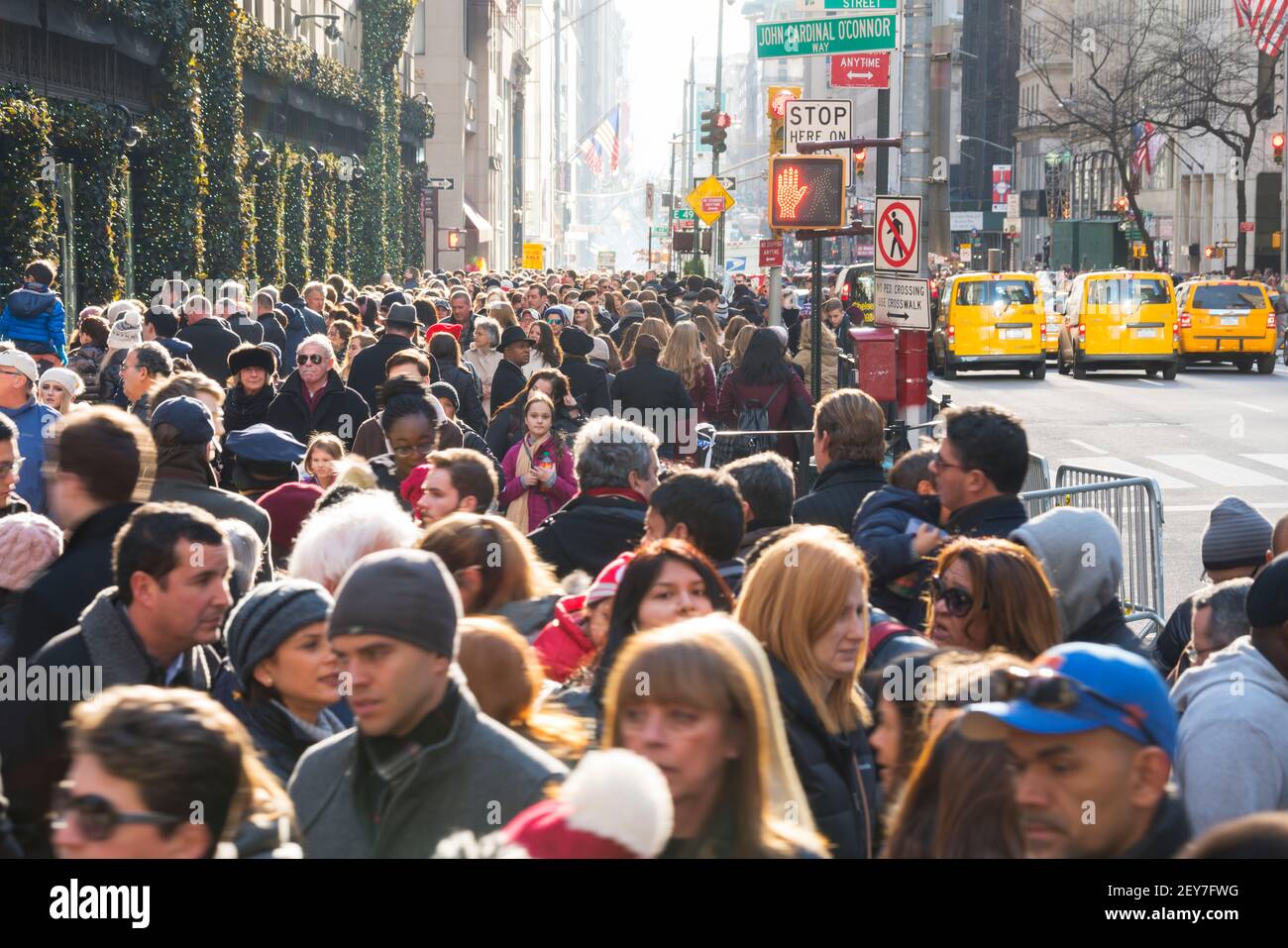A crowd of people walks on the Fifth Avenue during the Winter Holiday ...