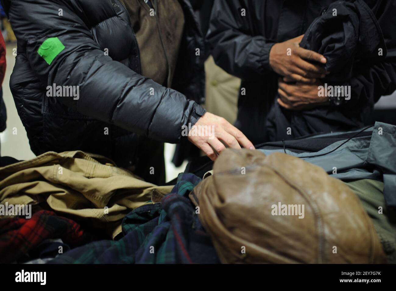 A man looks through a pile of donated coats during the 26th Annual Coat ...