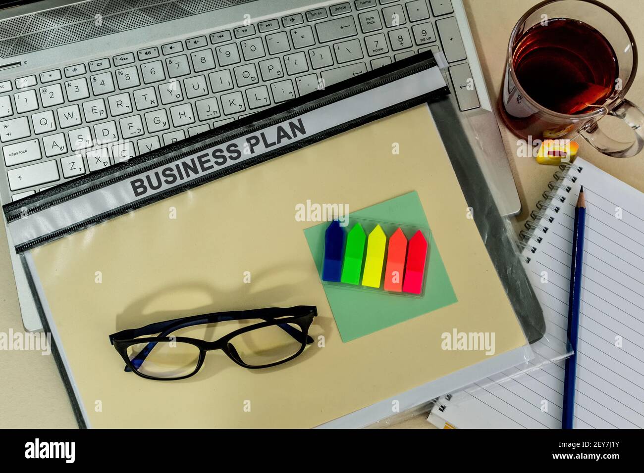 A top view of a folder labelled "BUSINESS PLANT" on a laptop in the ...