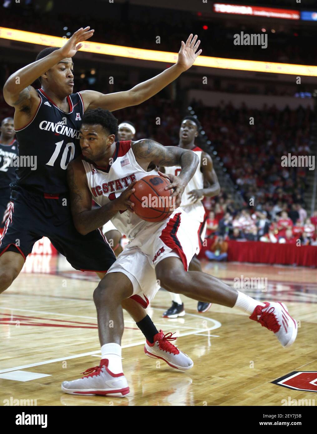 N.C. State's Trevor Lacey (1) tries to drive around Cincinnati's Troy ...