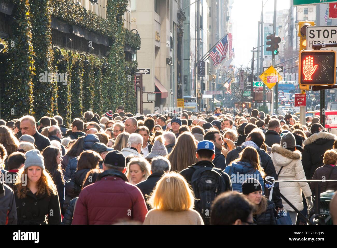 A crowd of people walks on the Fifth Avenue during the Winter Holiday ...