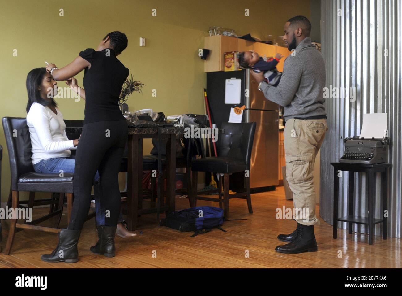 Bashir Hassan holds 6-week-old Idris as his wife, Lindette Hassan ...
