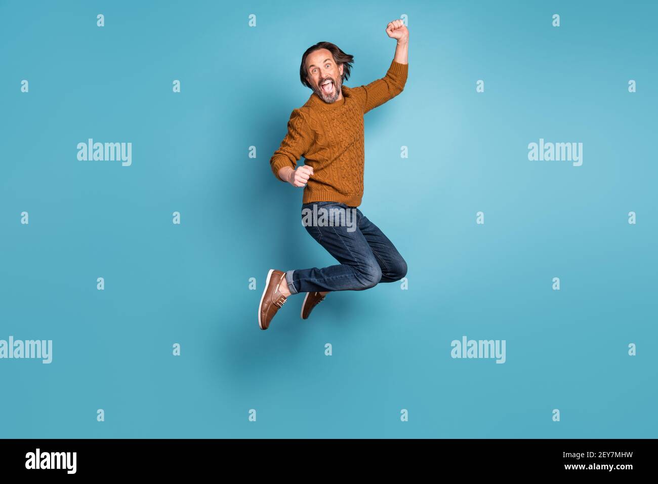 Full size photo of mature handsome excited crazy smiling man jumping in ...