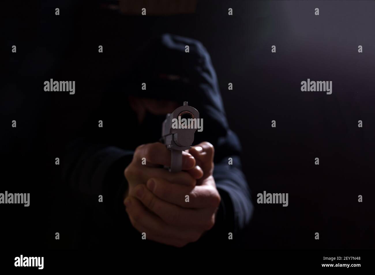 Gungter in the dark pointing with gun, on black background Stock Photo ...