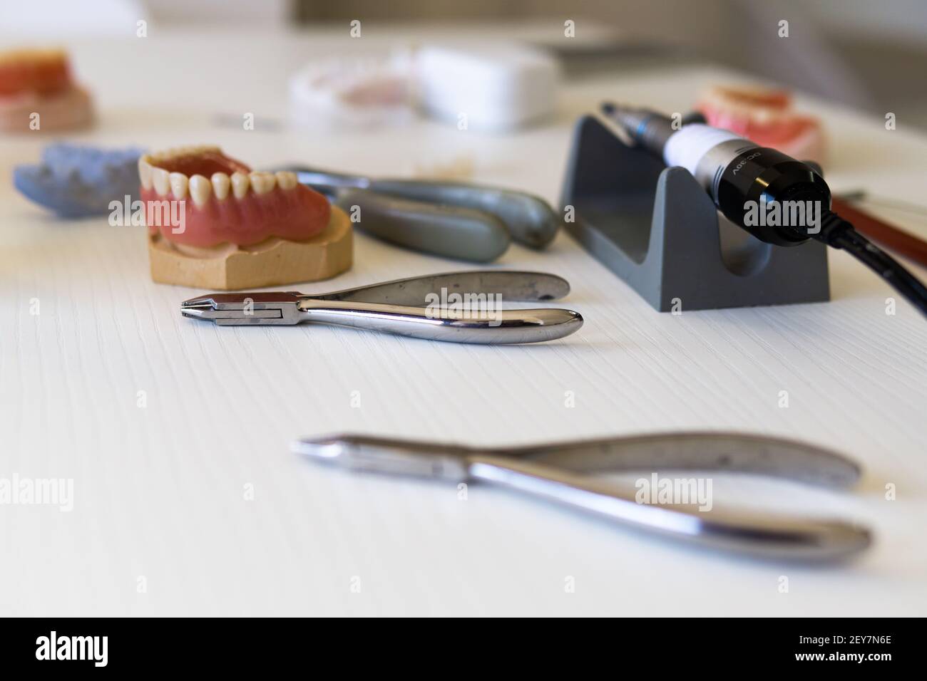 A closeup shot of a model of a prosthetic set of teeth and some special ...