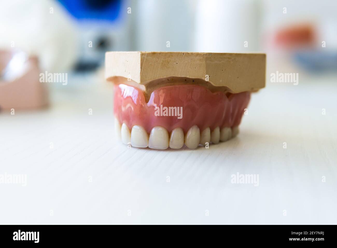 A closeup shot of a model of a prosthetic set of teeth in a dentist's ...