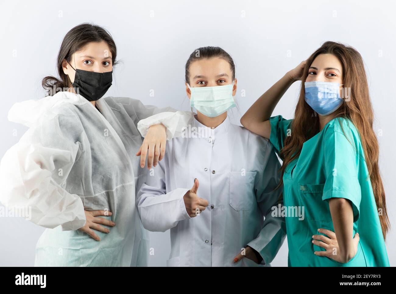 Three young female doctors standing and looking at camera Stock Photo ...