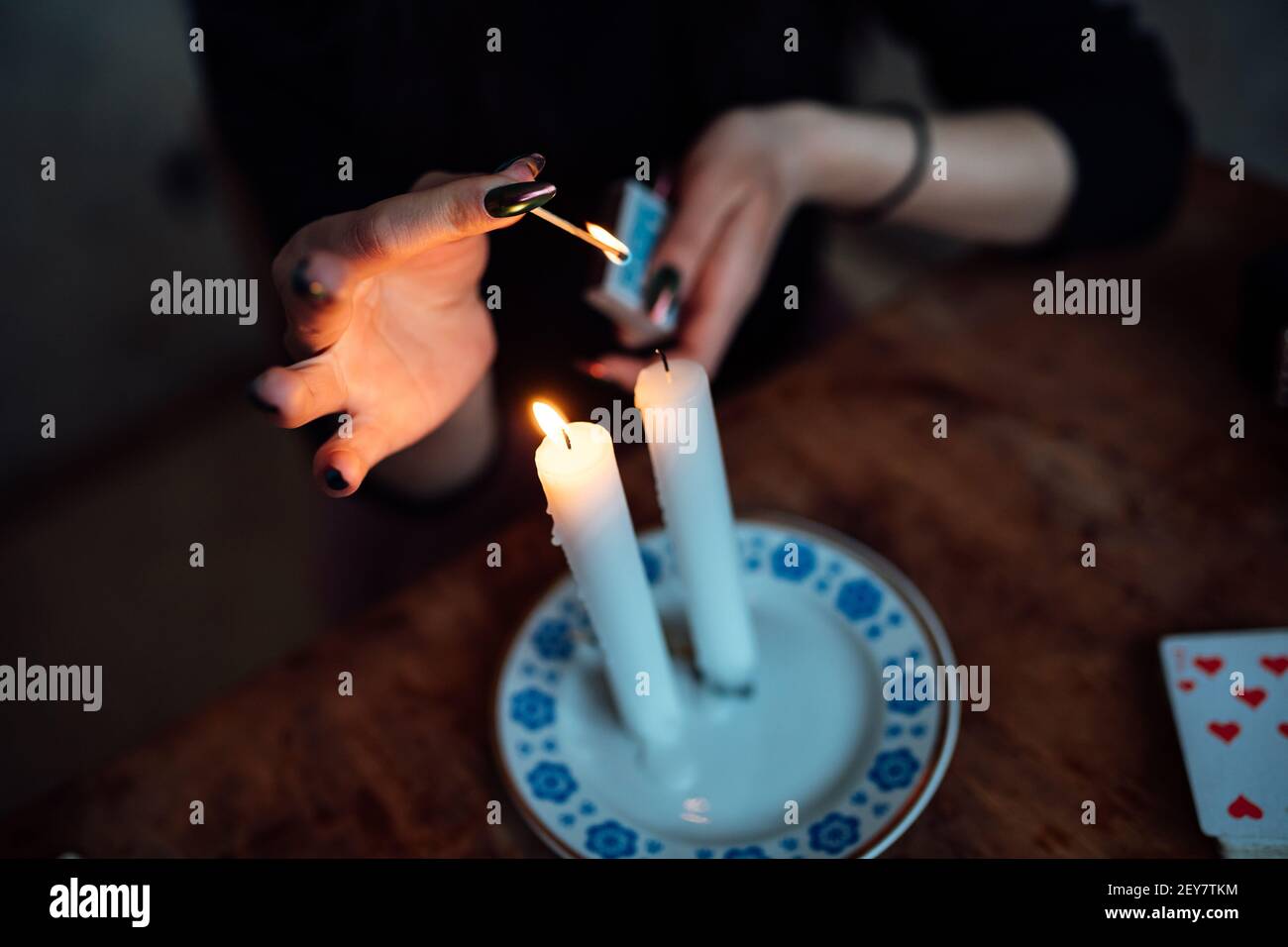 a fortune teller lights ritual candles to predict the future using ...