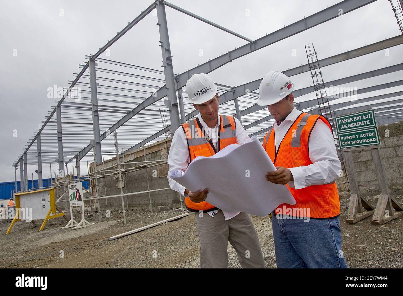 Construction workers George Estrella and Howard Lockward look over ...