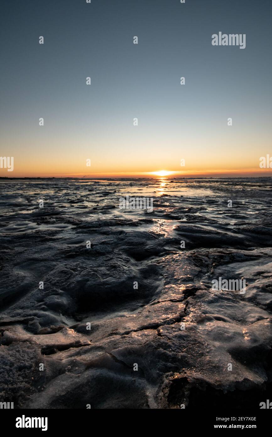 The frozen sea water at sunset Stock Photo - Alamy