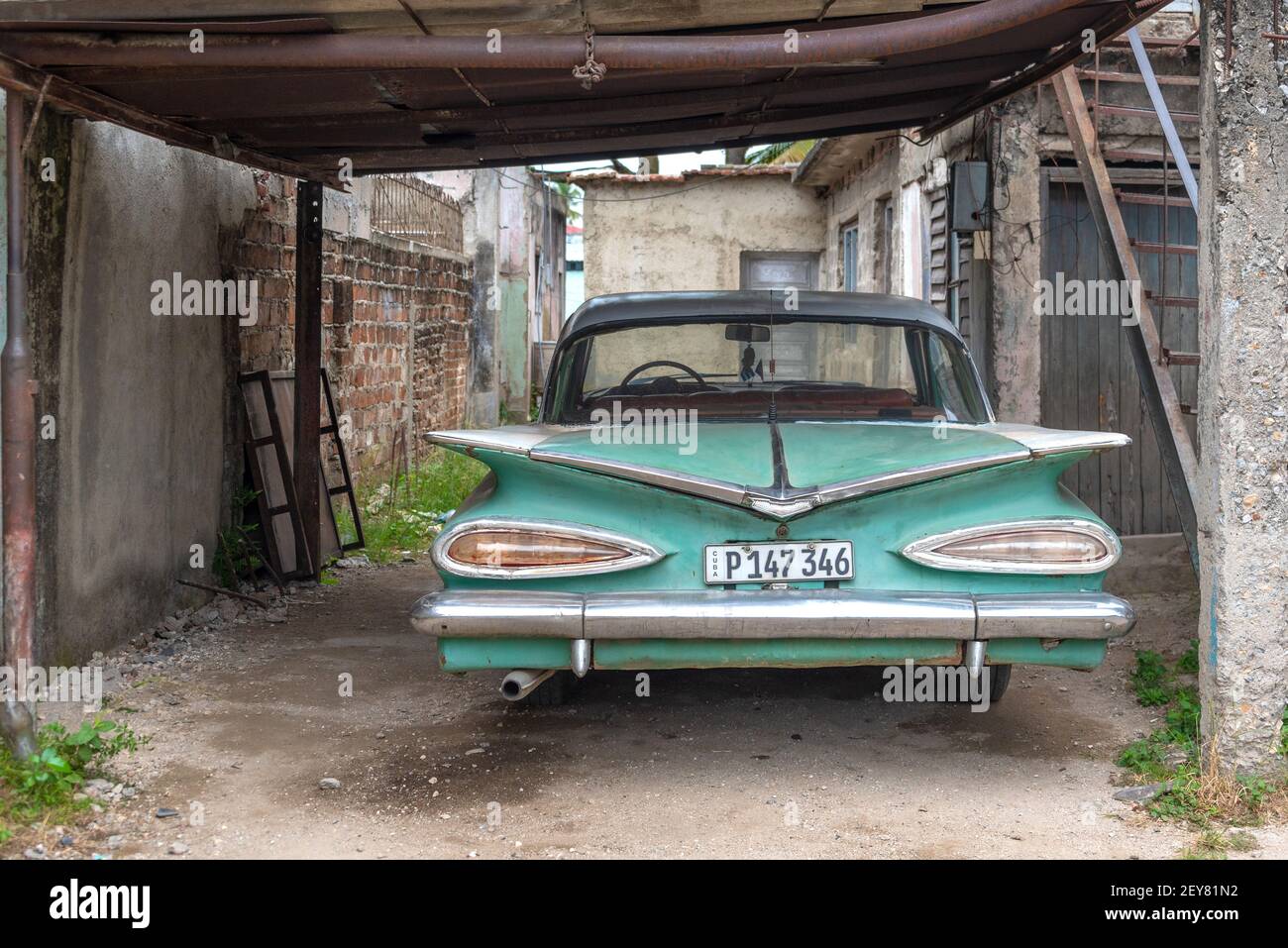 Vintage old American car in rustic garage building, Santa Clara, Cuba ...