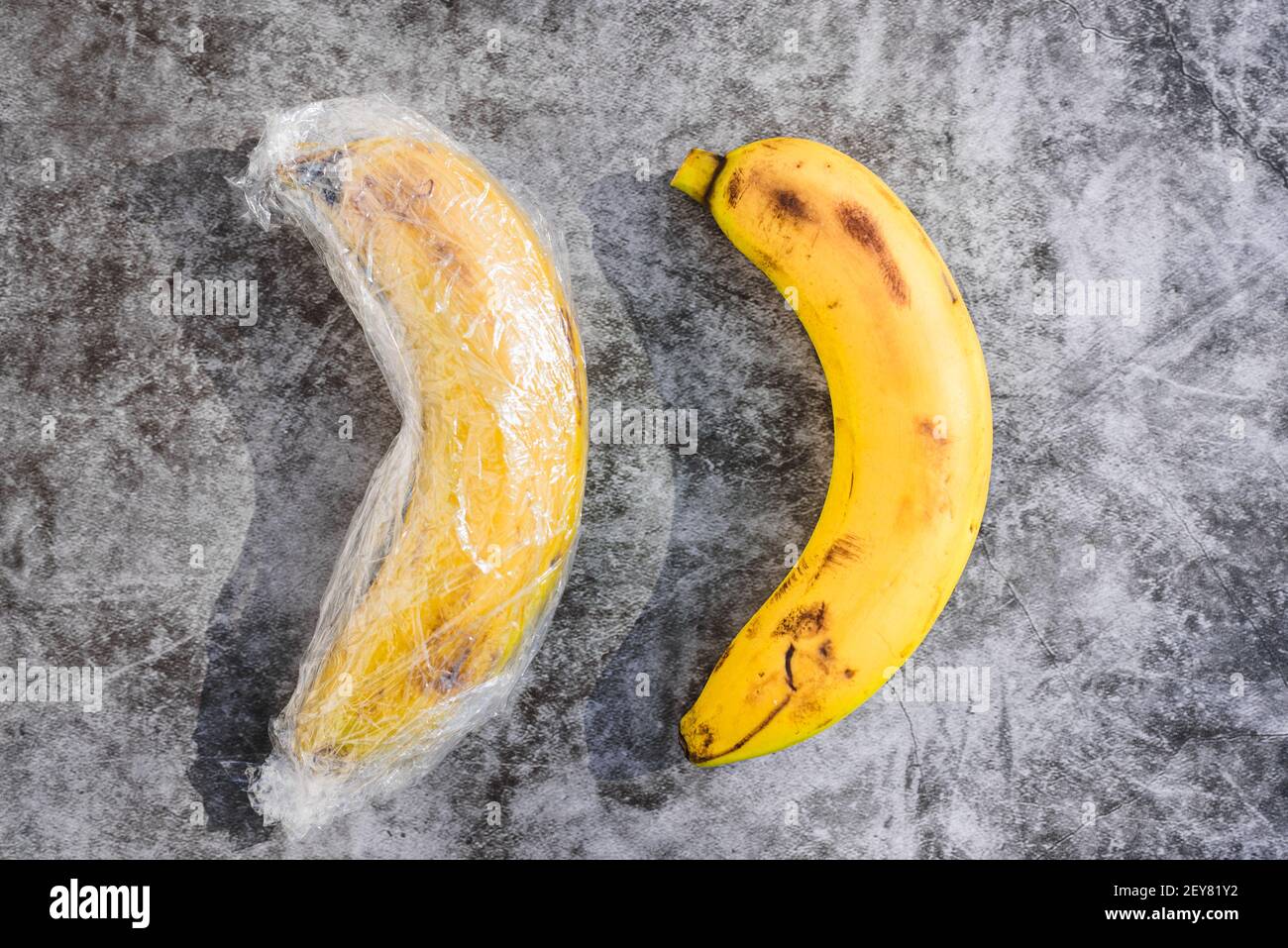 Bananas with natural peel wrapped in pointless plastic packaging Stock ...