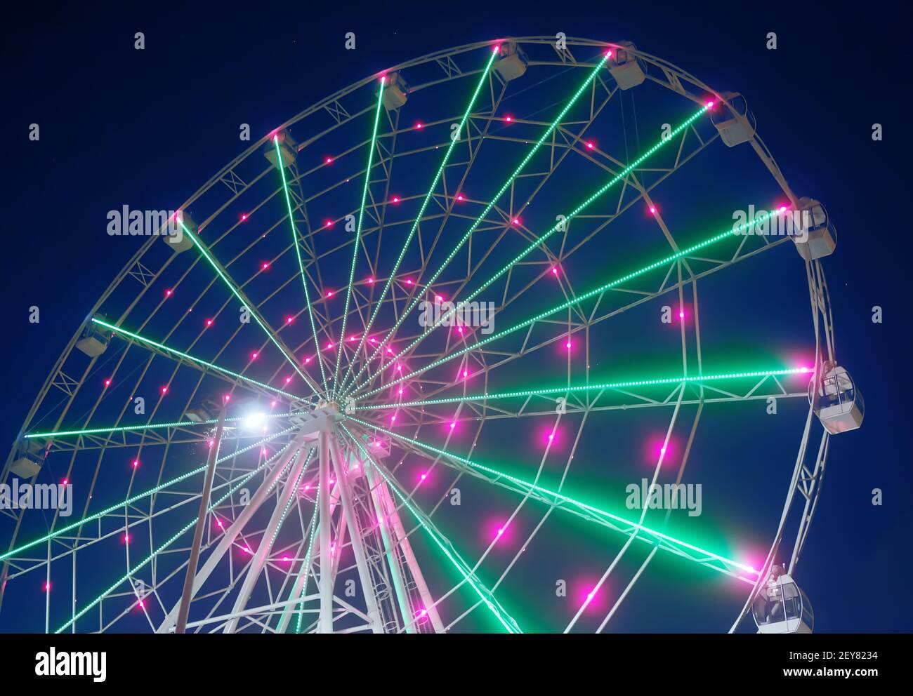 Carnival ride showing a spinning ferris wheel in action- long exposure ...