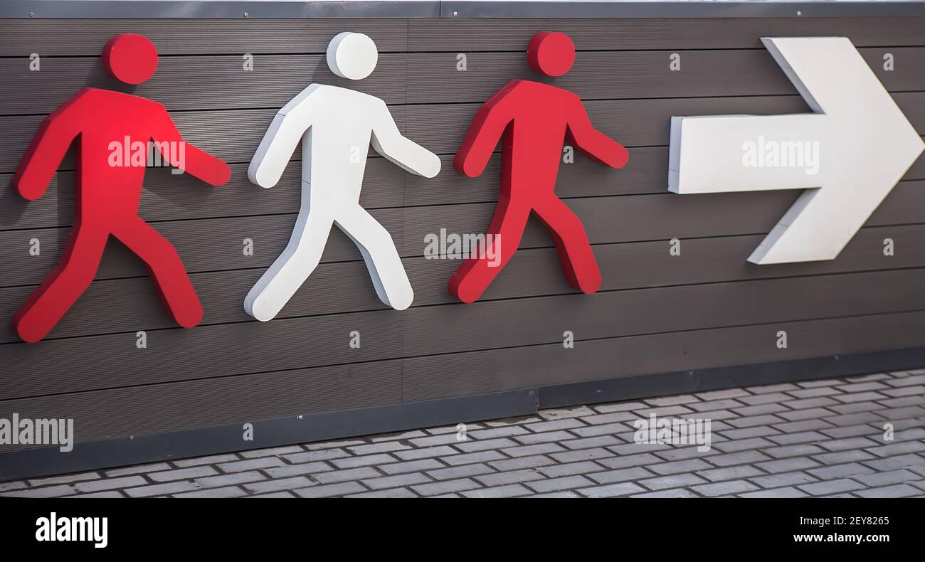 Three pictograms of person walking in direction of white arrow Stock ...