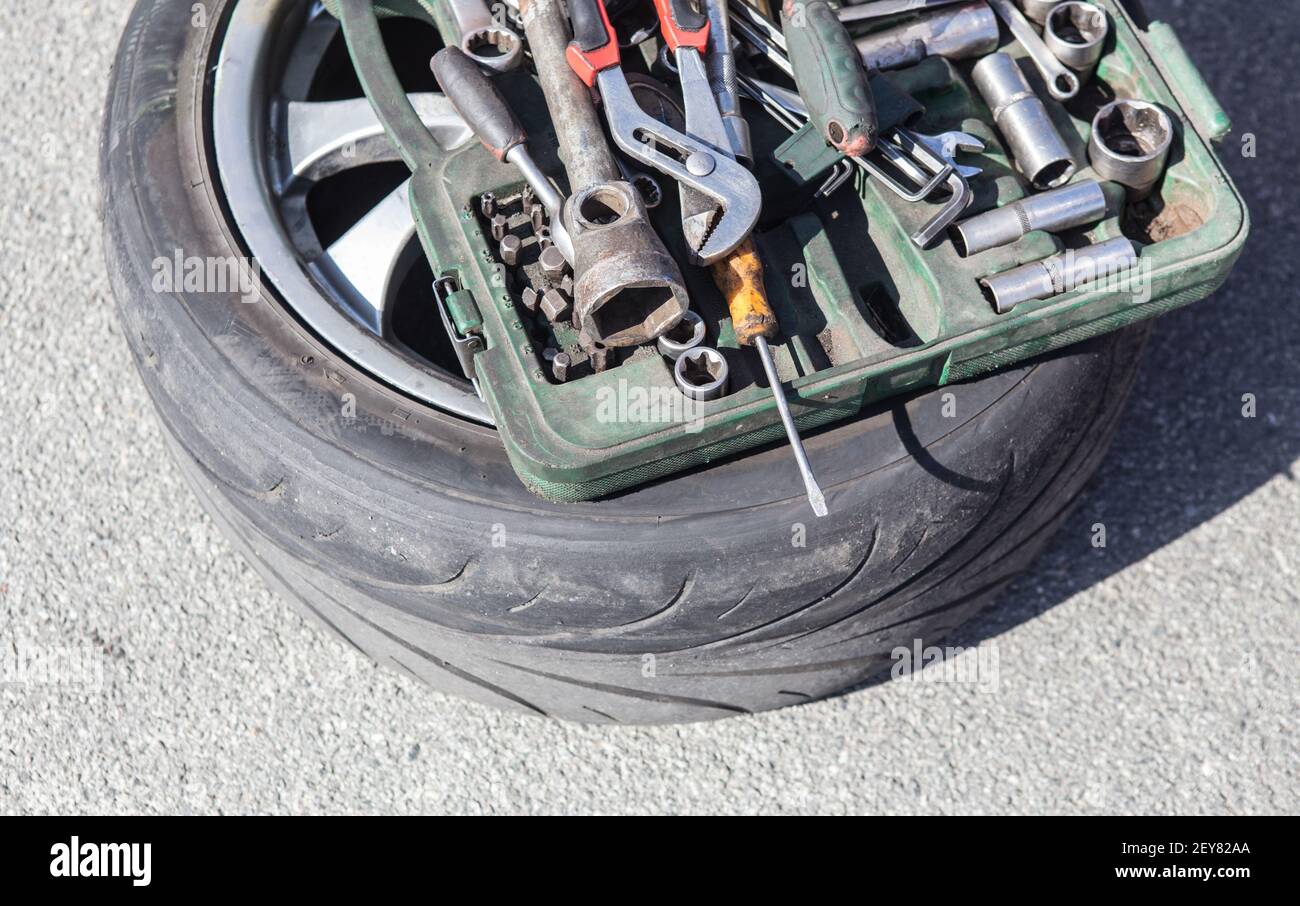 car wheel and tool box on the road Stock Photo - Alamy