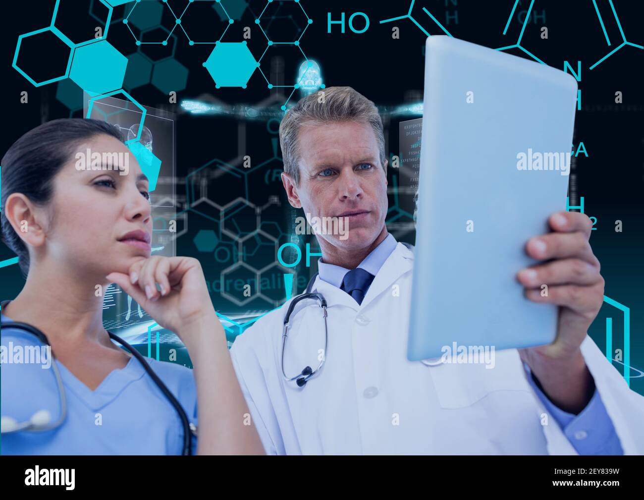 Female and male doctors using tablet with chemical compounds and ...