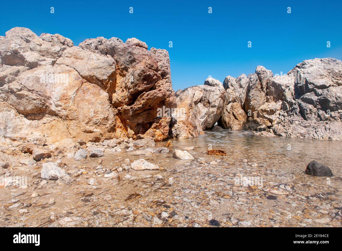 Rocky grottoes on a picturesque beach on the Kos island, Greece Stock ...