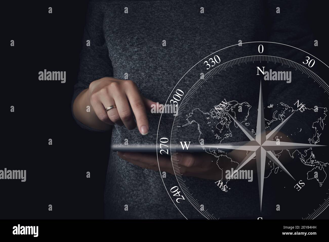 Human hands holding digital tablet with hologram Compass. Travel ...