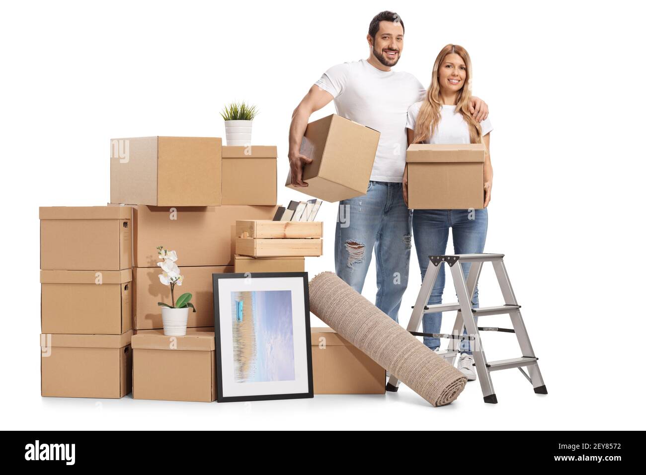 Young couple packing for removal with a pile of cardboard boxes ...