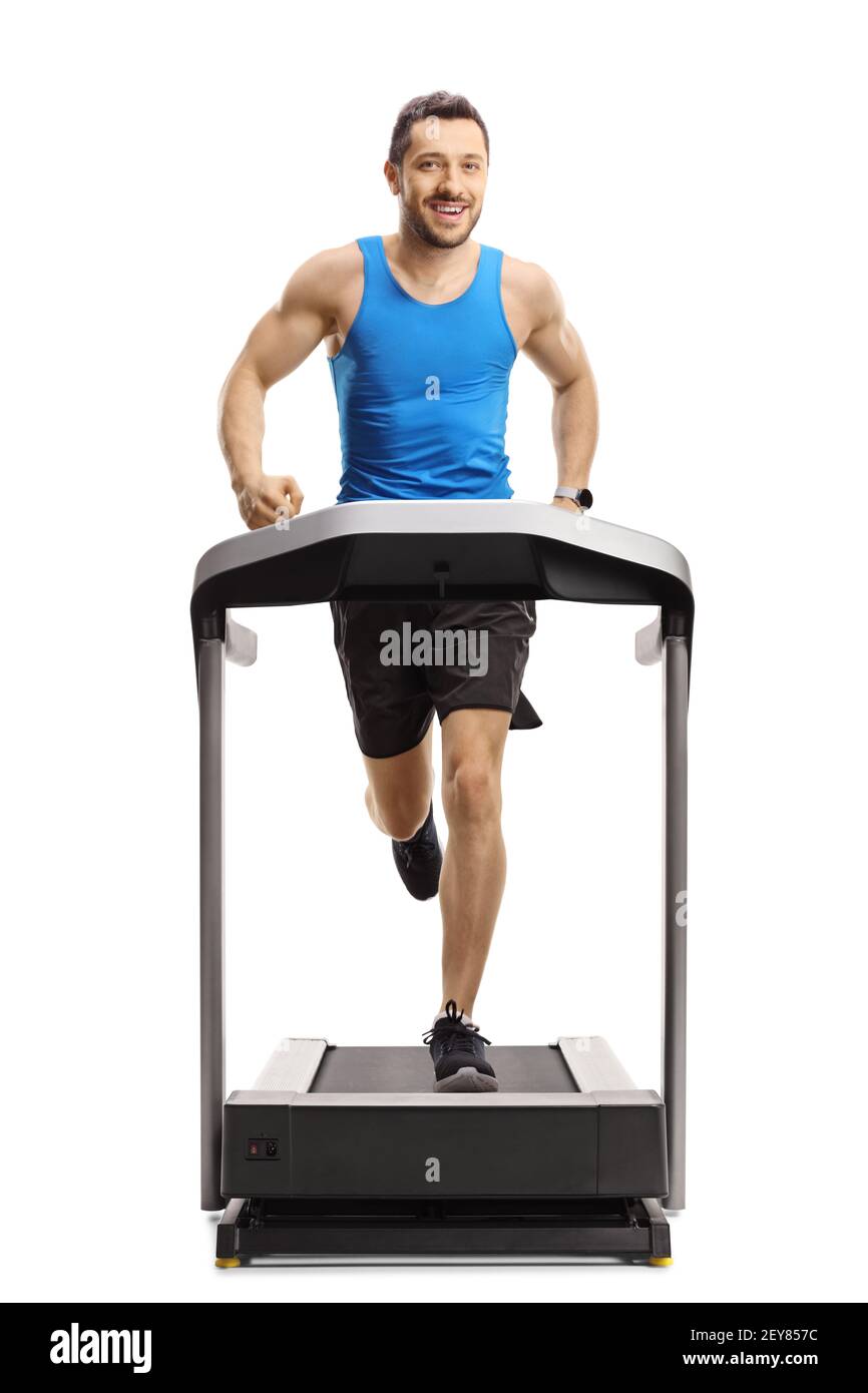 Full length portrait of a man in sportswear running on a treadmill and ...
