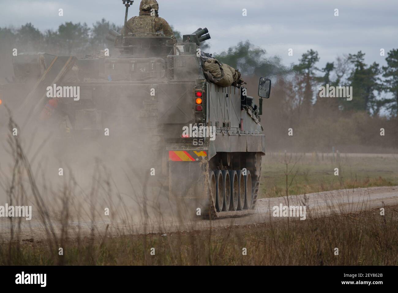 british army FV512 warrior MRV tank kicking up clouds of dust on ...