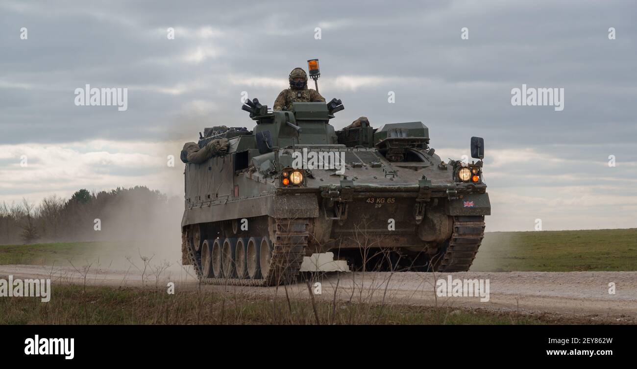 british army FV512 warrior MRV tank kicking up clouds of dust on ...