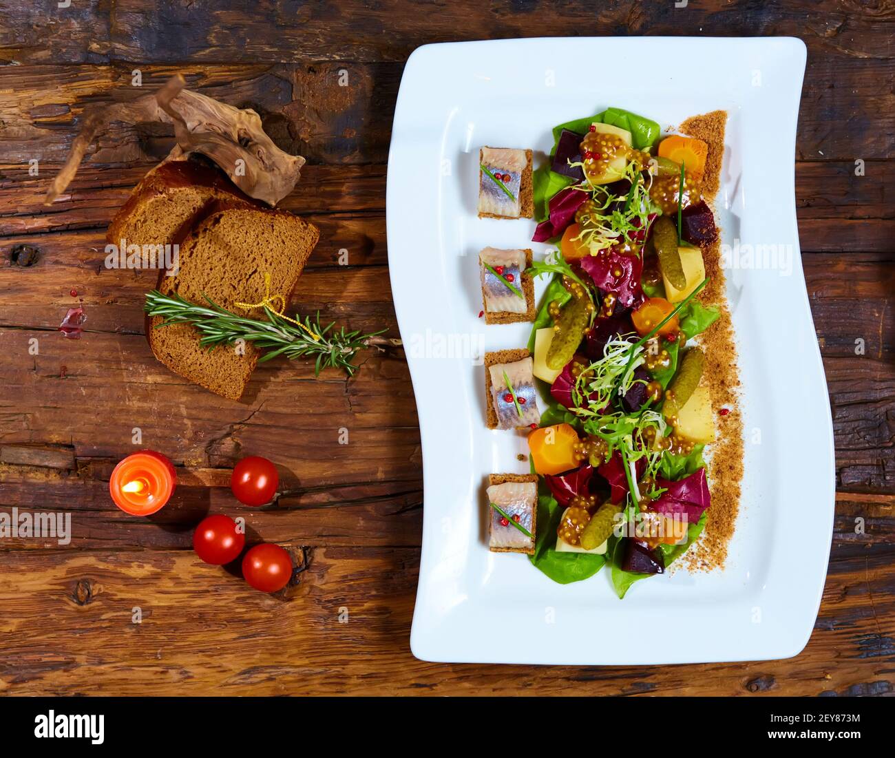 Canape from rye bread with herring slice Stock Photo - Alamy