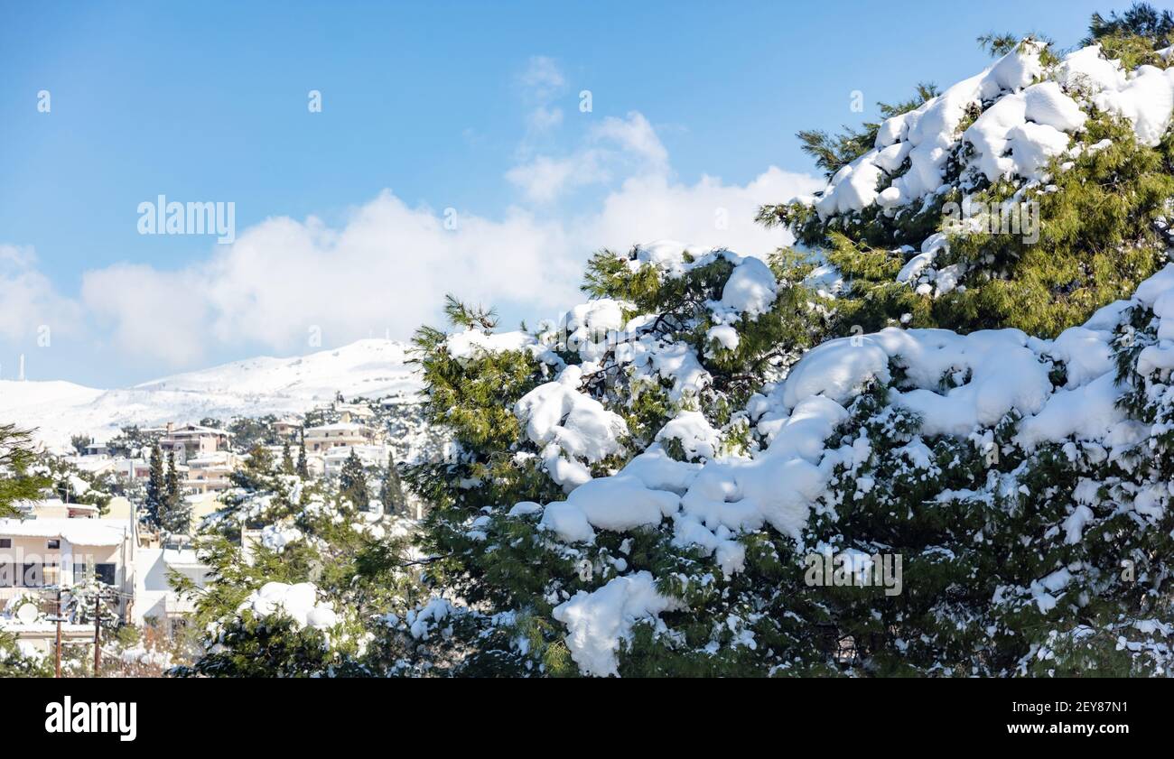 Snow of winter over city concept. Snowy buildings, mountains and ...
