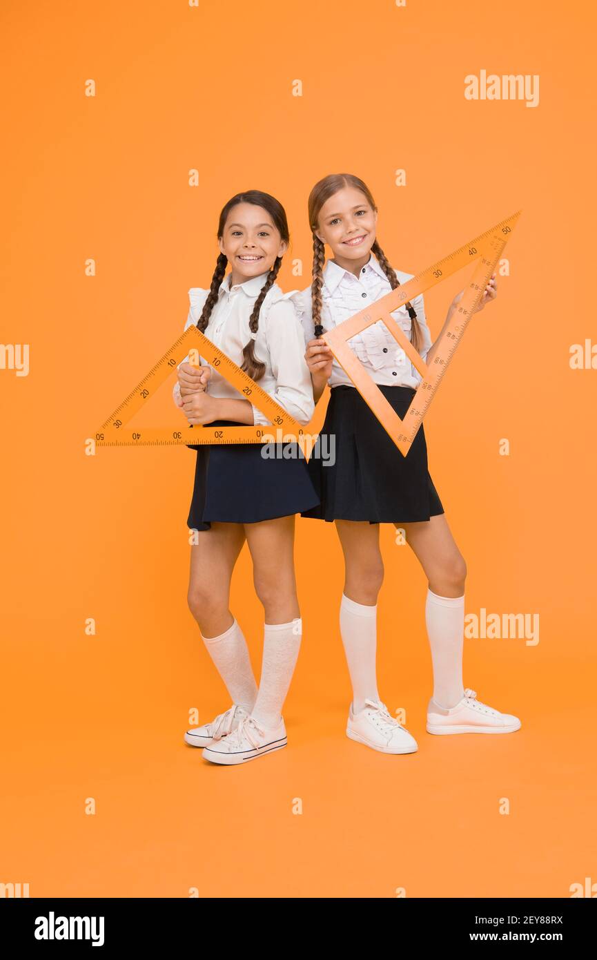 School students study geometry. Pupil school girls big rulers. School ...