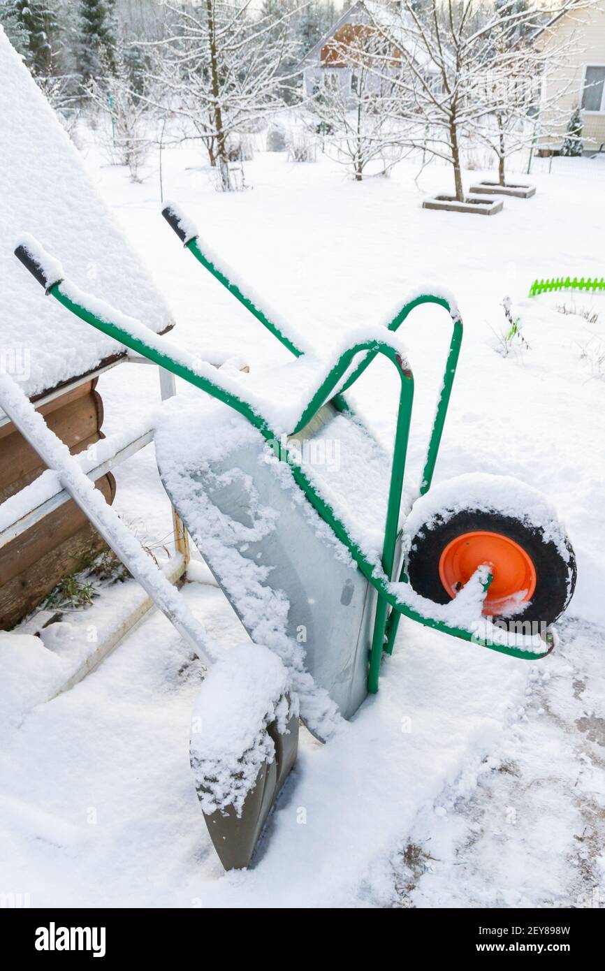 Metal garden wheelbarrow in the snow in winter Stock Photo - Alamy