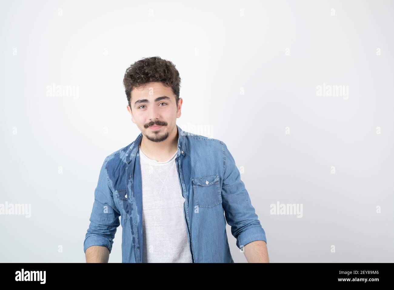 Portrait photo of a young handsome man model with mustache standing ...