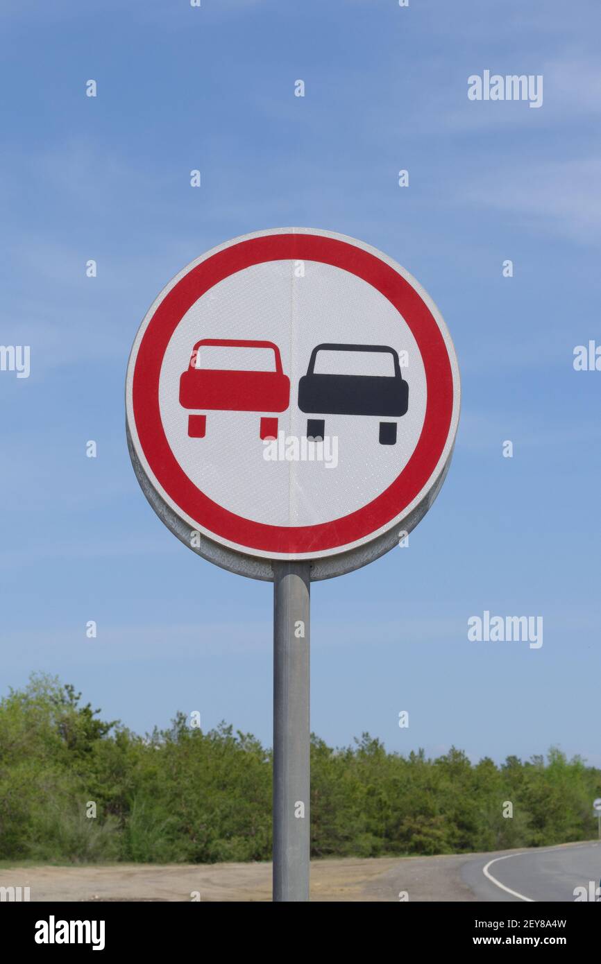 Road sign prohibiting overtaking. Warning to drivers on dangerous ...