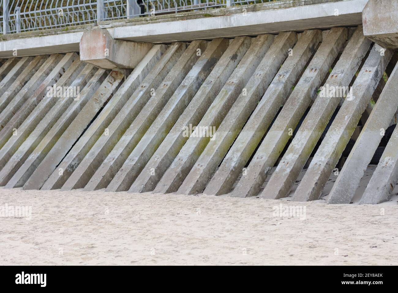 Concrete piles fortification on seashore. Construction of pedestrian ...