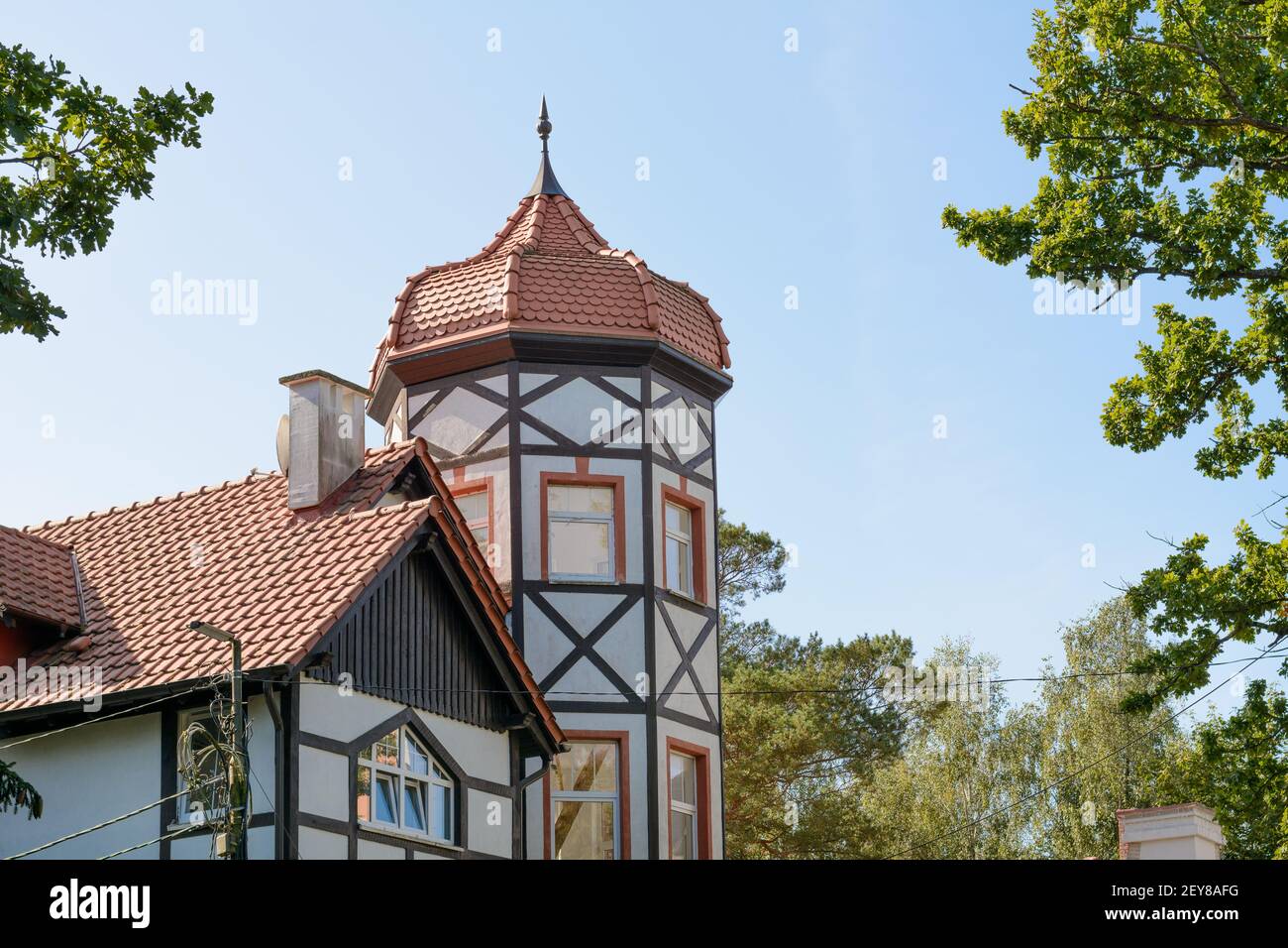Building is tower with windows and half-timbered decoration. Roof made ...