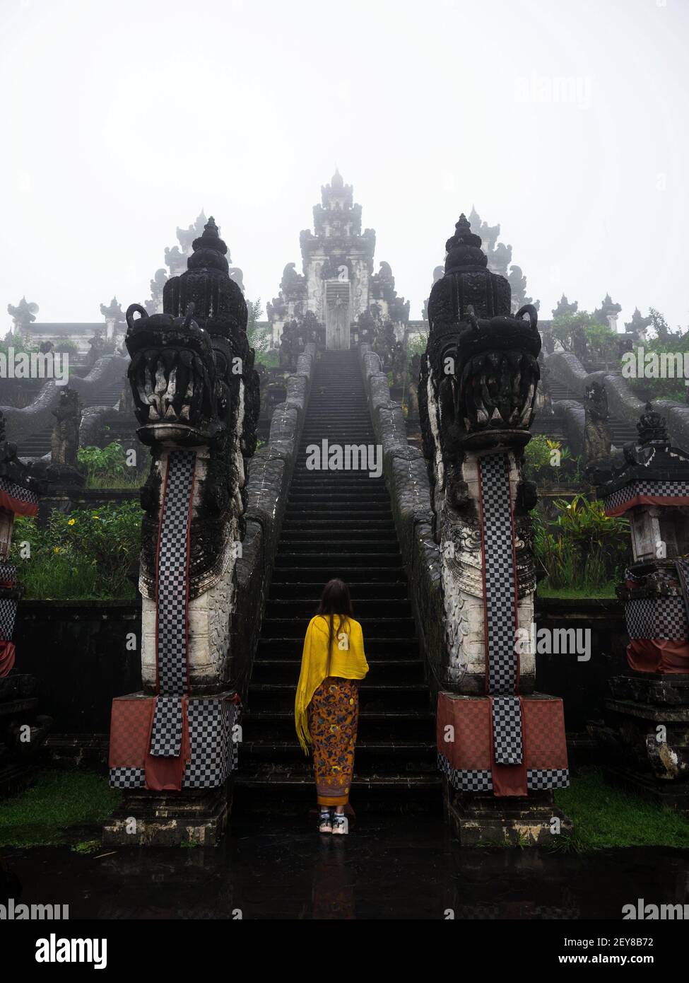 Young female tourist standing infront of dragon stairs staircase ...
