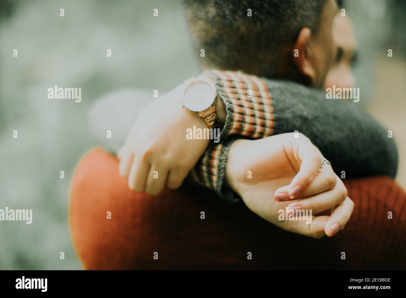 A beautiful romantic couple; hands of a woman around a man's neck Stock ...