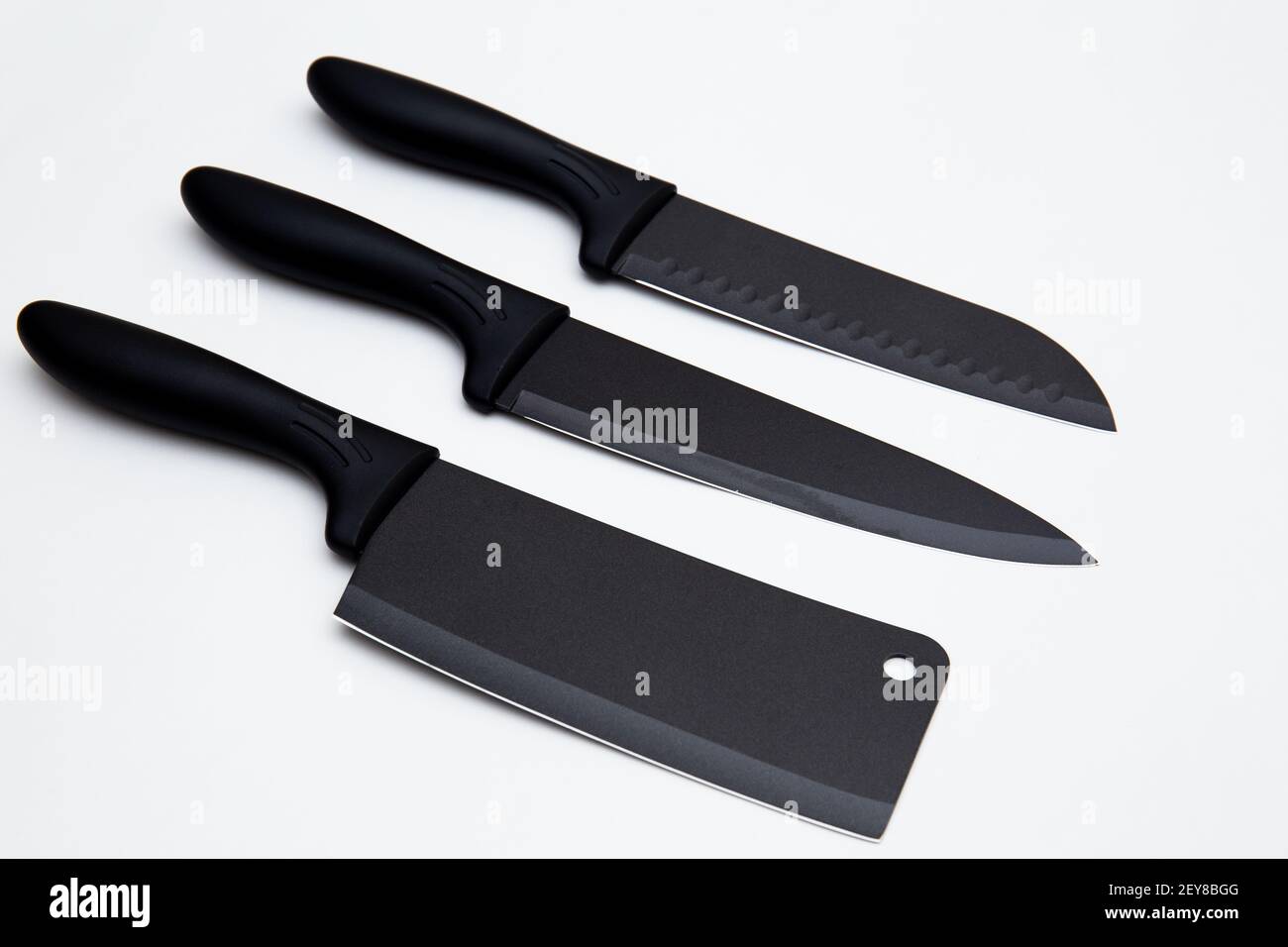 A side view of different sized black matte sharp knives isolated in ...