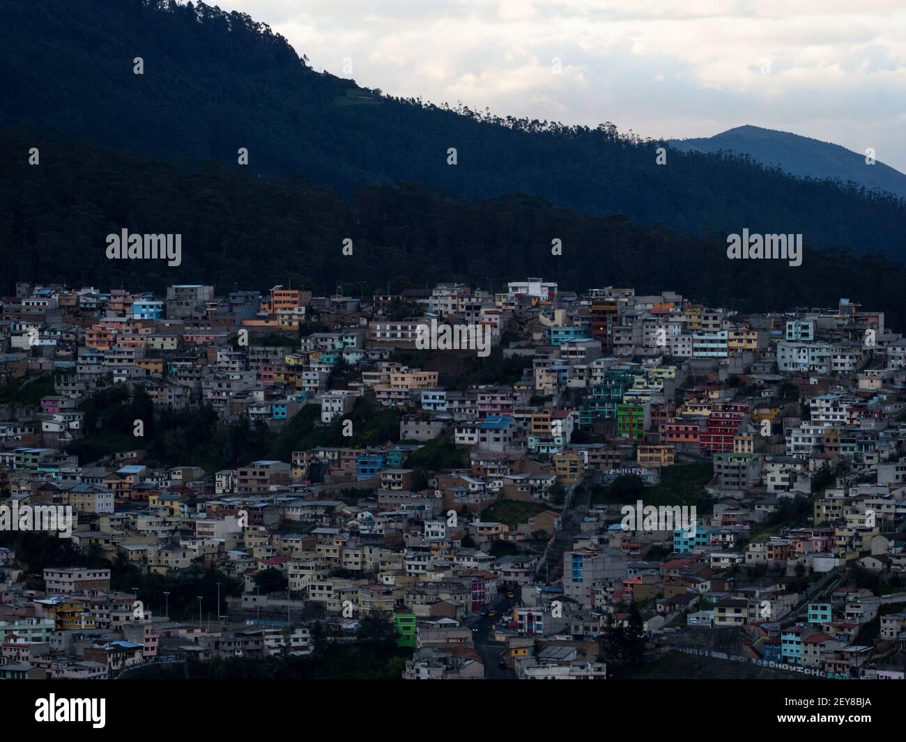 Aerial cityscape panorama of Quito skyline colorful houses buildings poverty slums from El ...