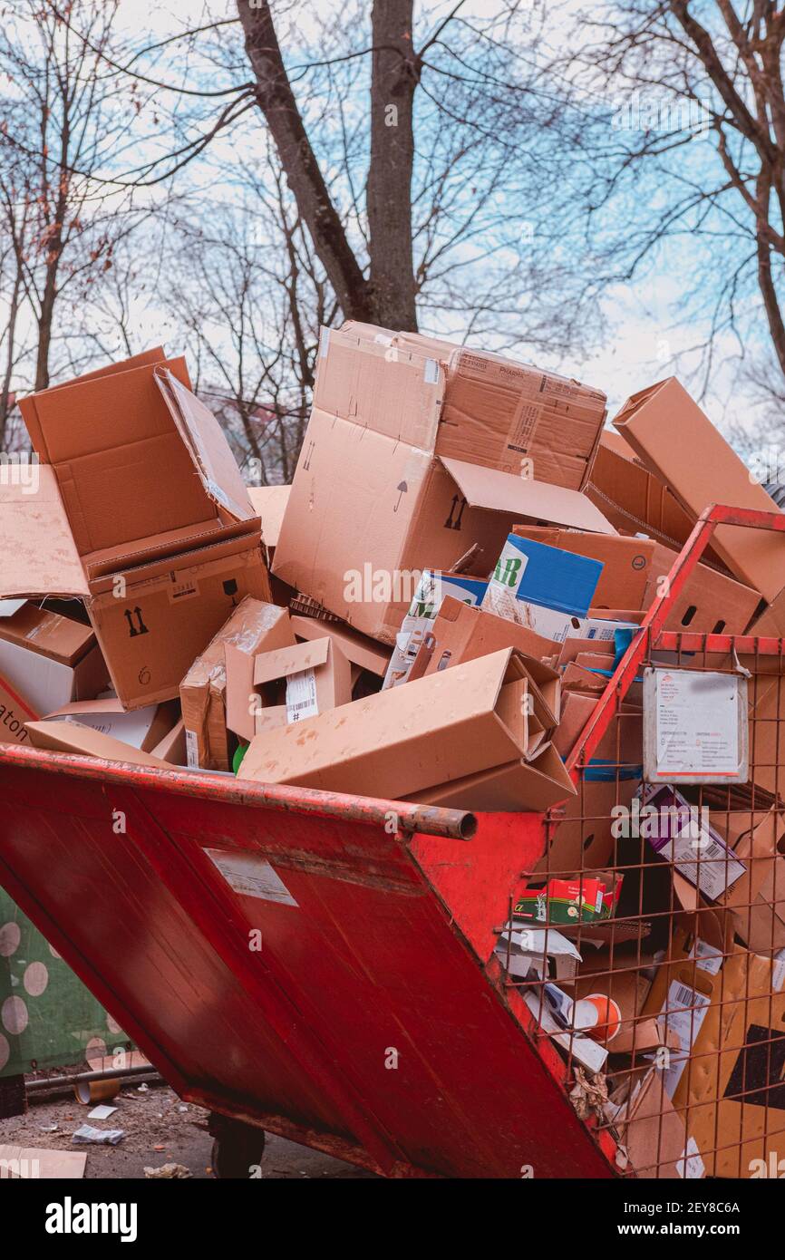 A vertical shot of a heap of cardboard boxes in a garbage Stock Photo ...