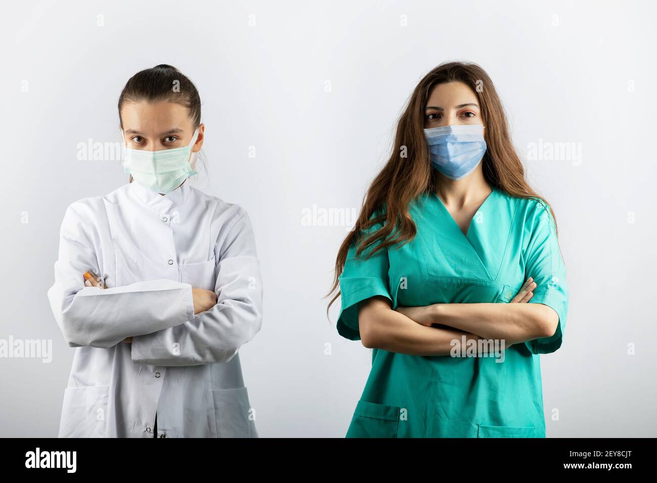 Two female nurses in medical masks looking at camera Stock Photo - Alamy