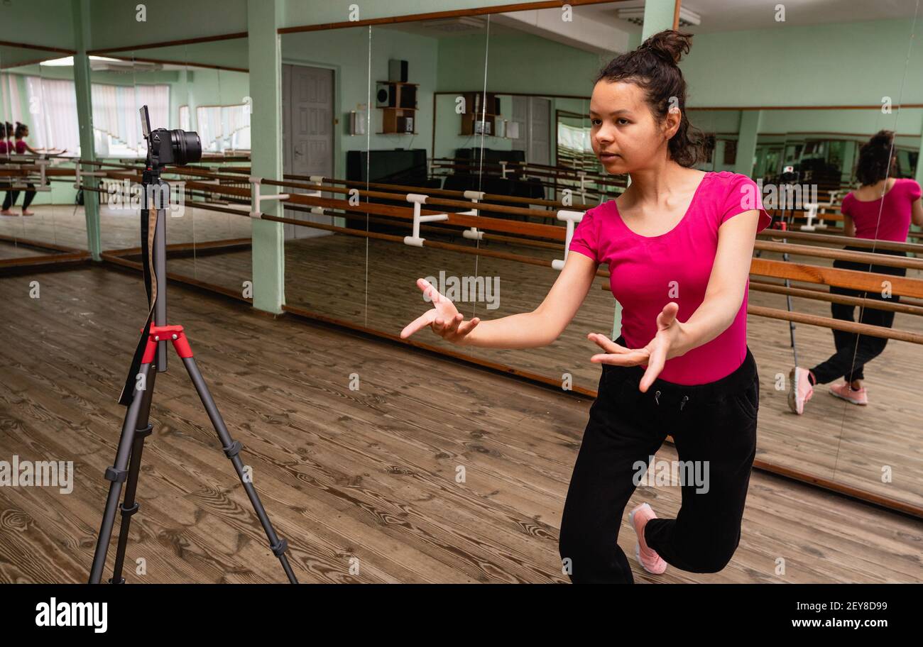 Young woman recording on camera a dance lesson in a choreography hall ...