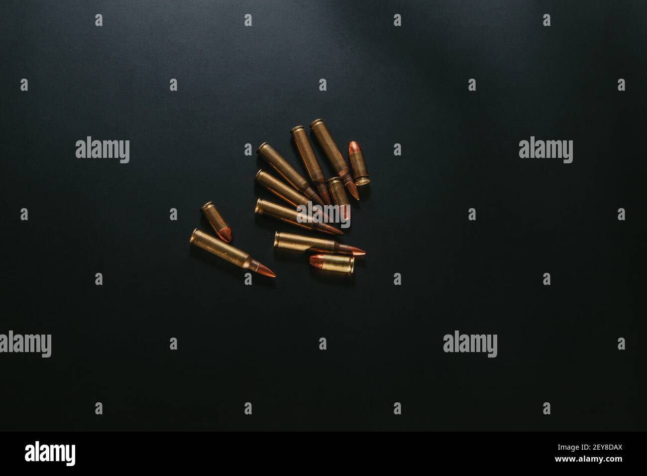 A top view of bullets on a black surface Stock Photo - Alamy