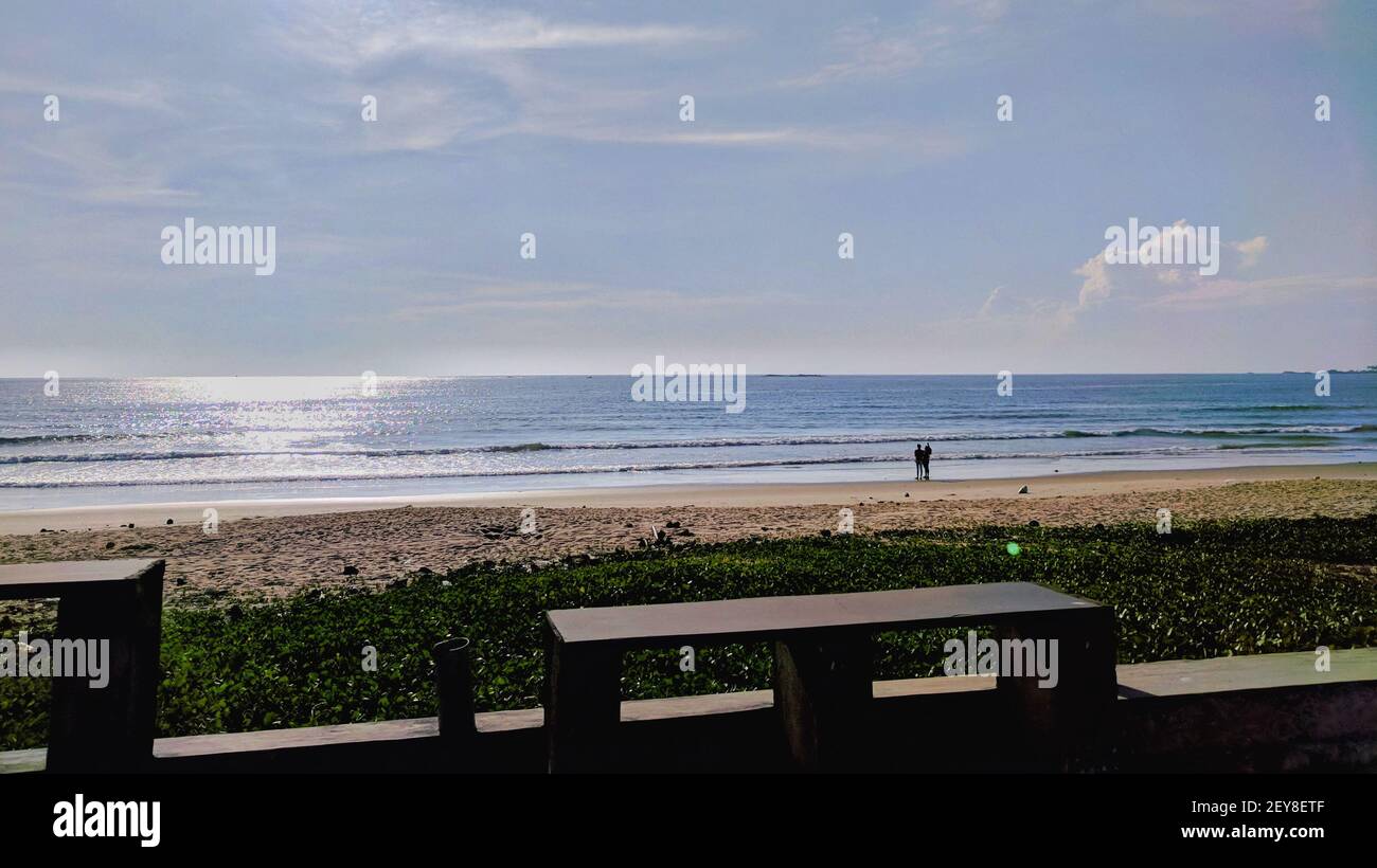 A mesmerizing view of the wavy ocean hitting the sandy beach under the ...