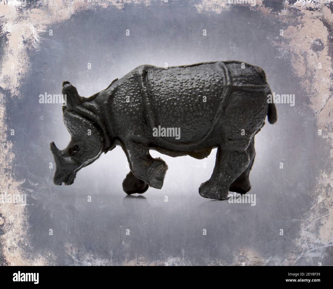 A closeup of a rhinoceros miniature on a rustic background Stock Photo ...