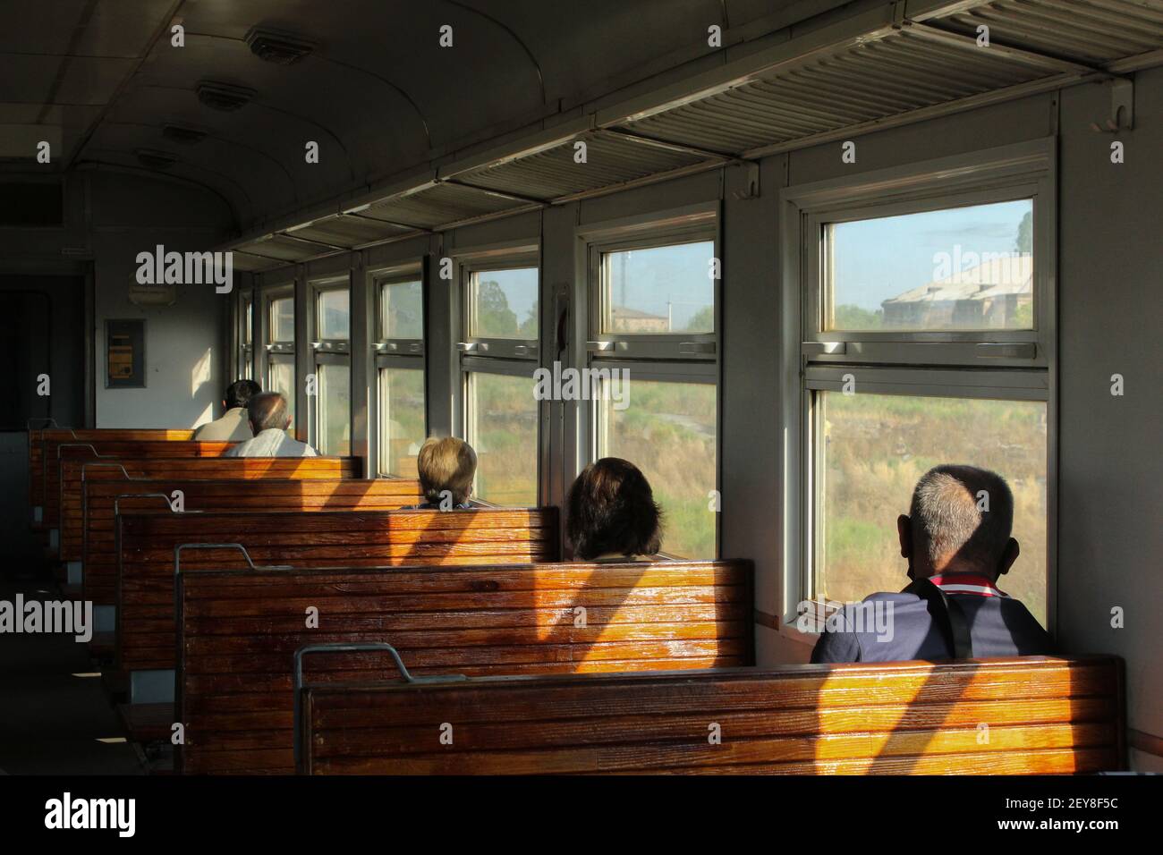 A group of people looking outside the window through train windows ...