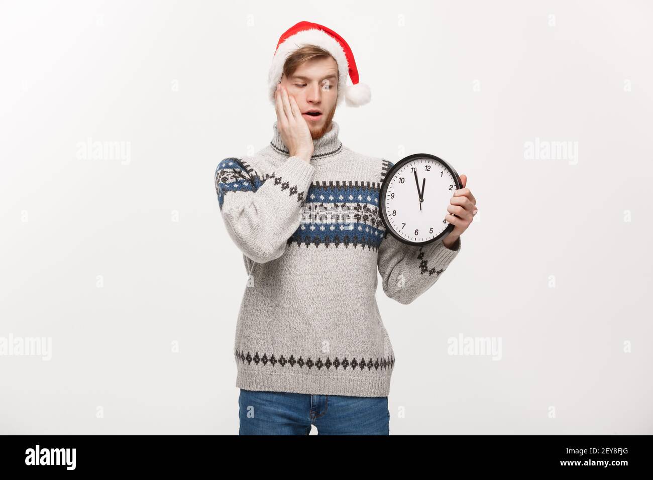 Holiday concept - Young happy handsome beard man in sweater holding ...