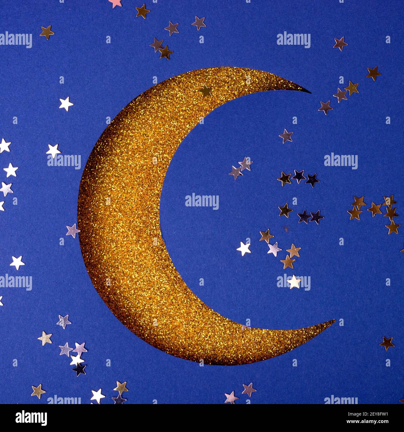 Crescent moon Cut out of paper on a glitter background with empty space ...