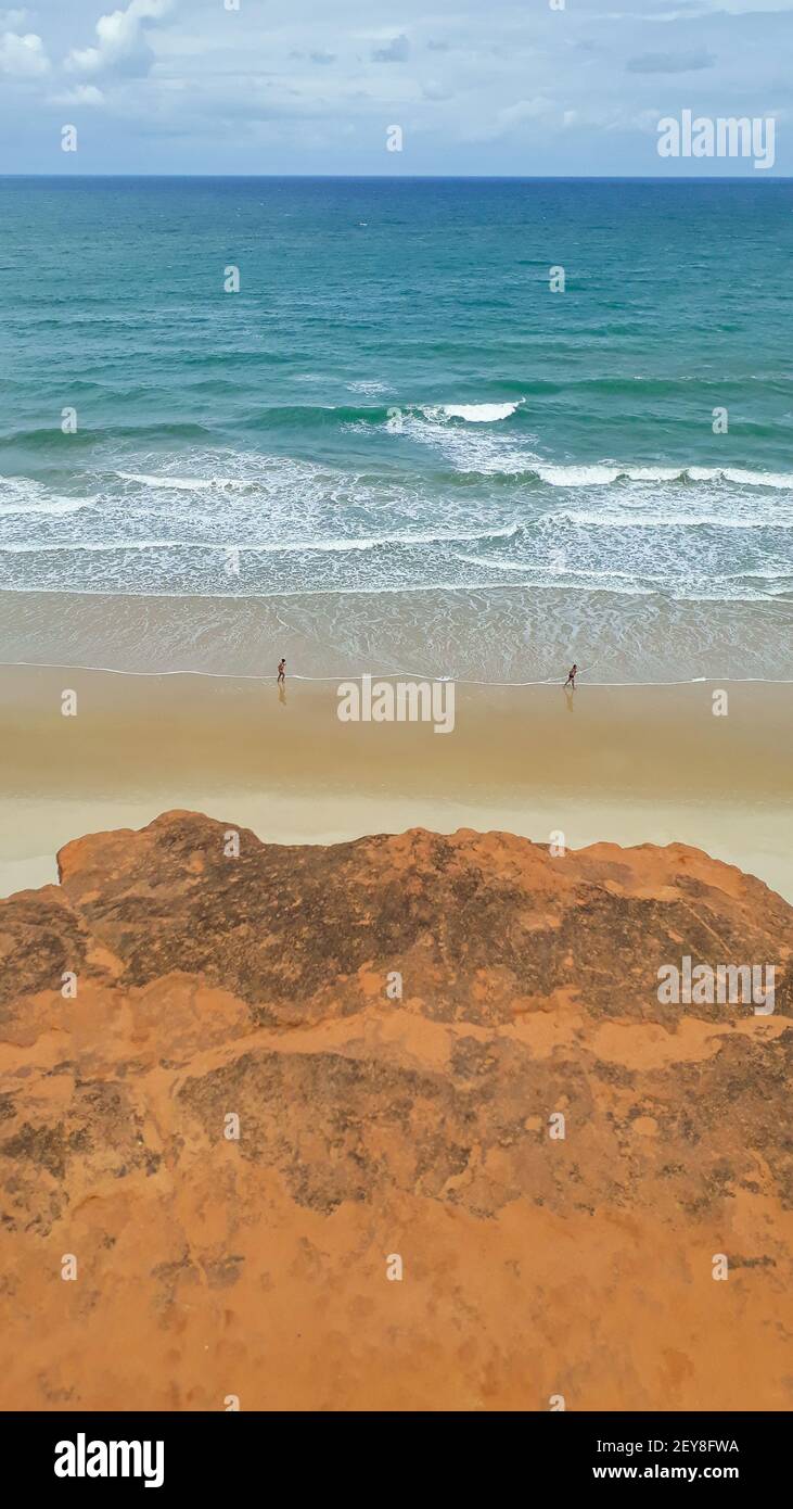 A beautiful view of the wavy ocean hitting the sandy beach on the coast ...